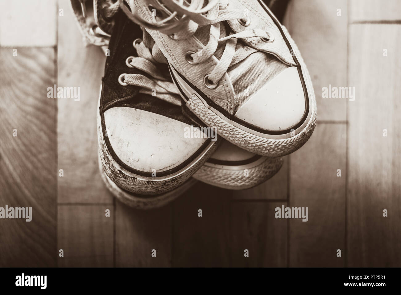 Old shoes on brown wood background Stock Photo - Alamy