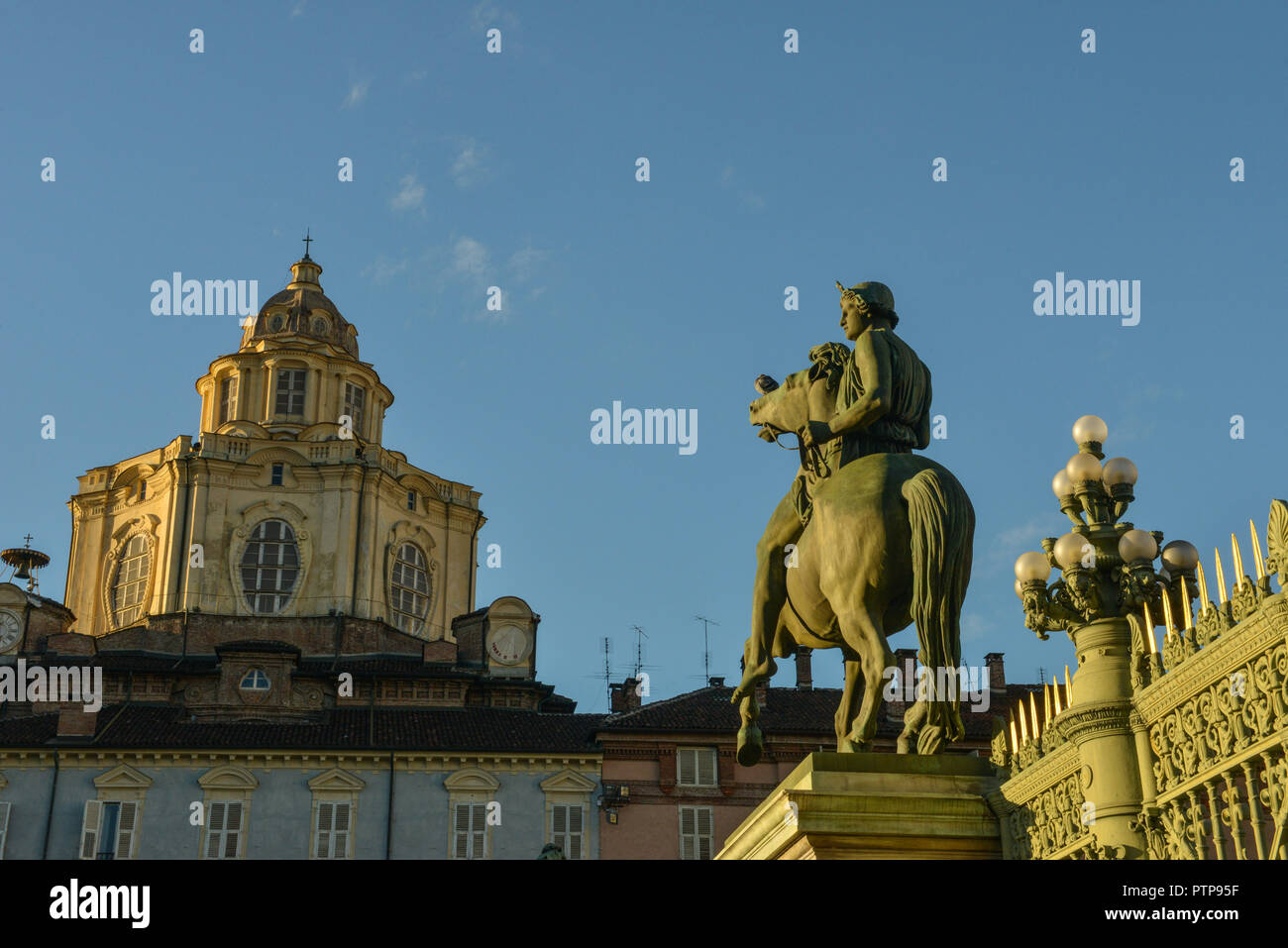 Italy, Turin: statue in “piazetta Reale” square and dome of the Church ...