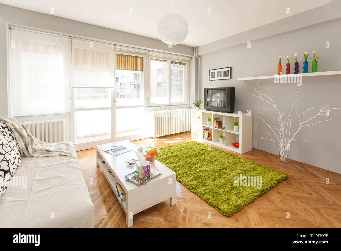 Bright living room with sofa and coffee table, white interior design ...
