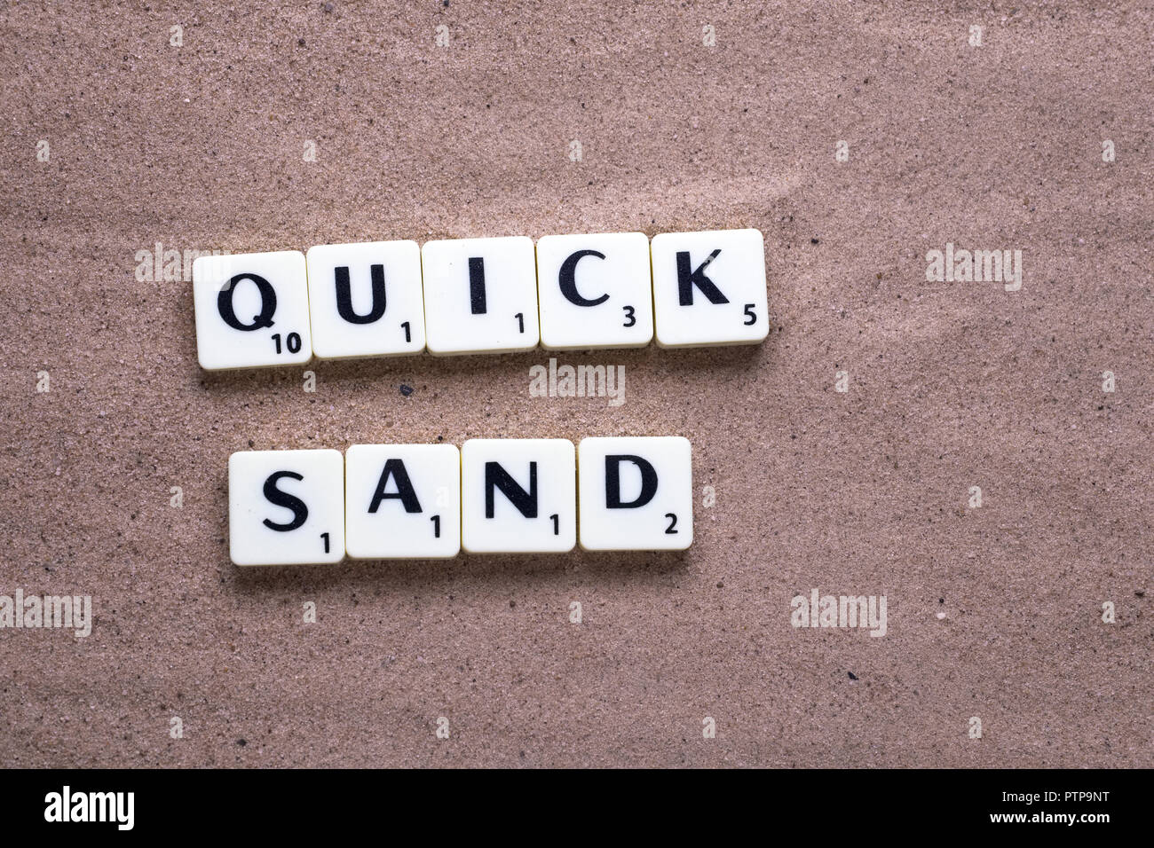 Quick sand letters on beach Stock Photo - Alamy