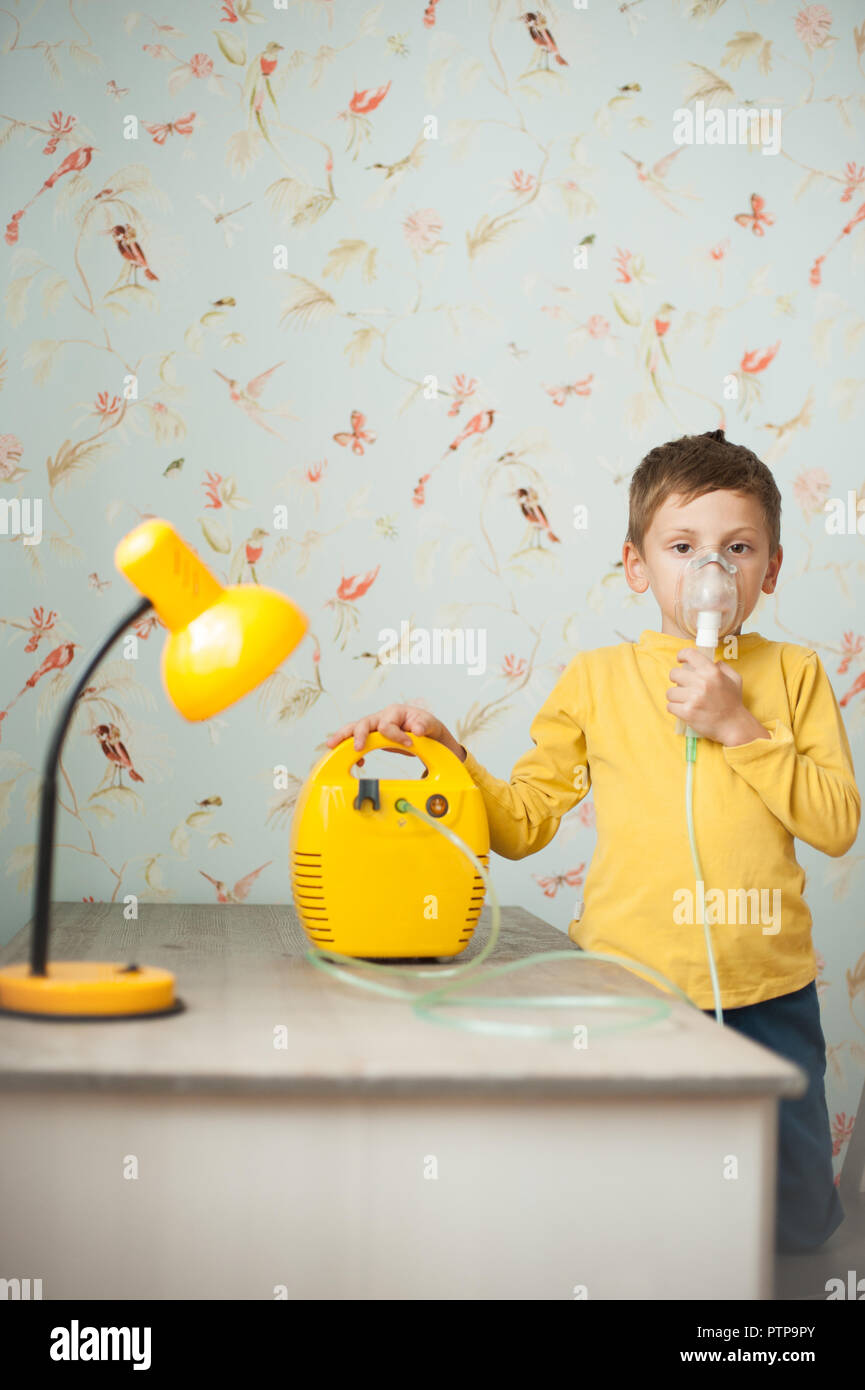 cute little sick caucasian child with device for inhalation in kids ...