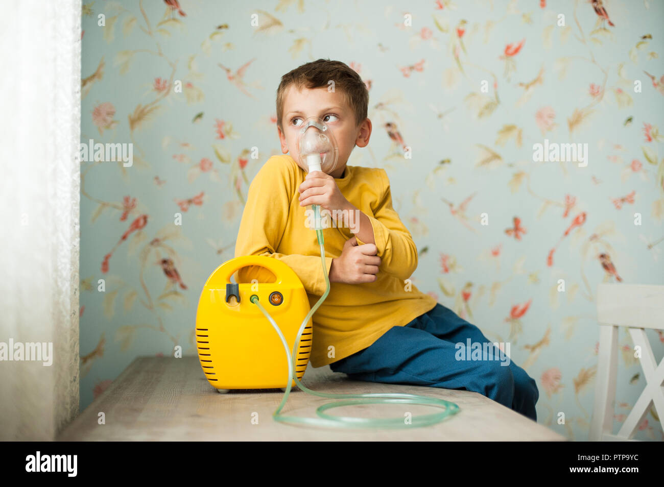 cute little sick caucasian child with device for inhalation in kids ...