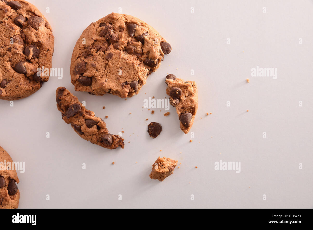 Breakfast with round biscuits with black chocolate chips on white table ...