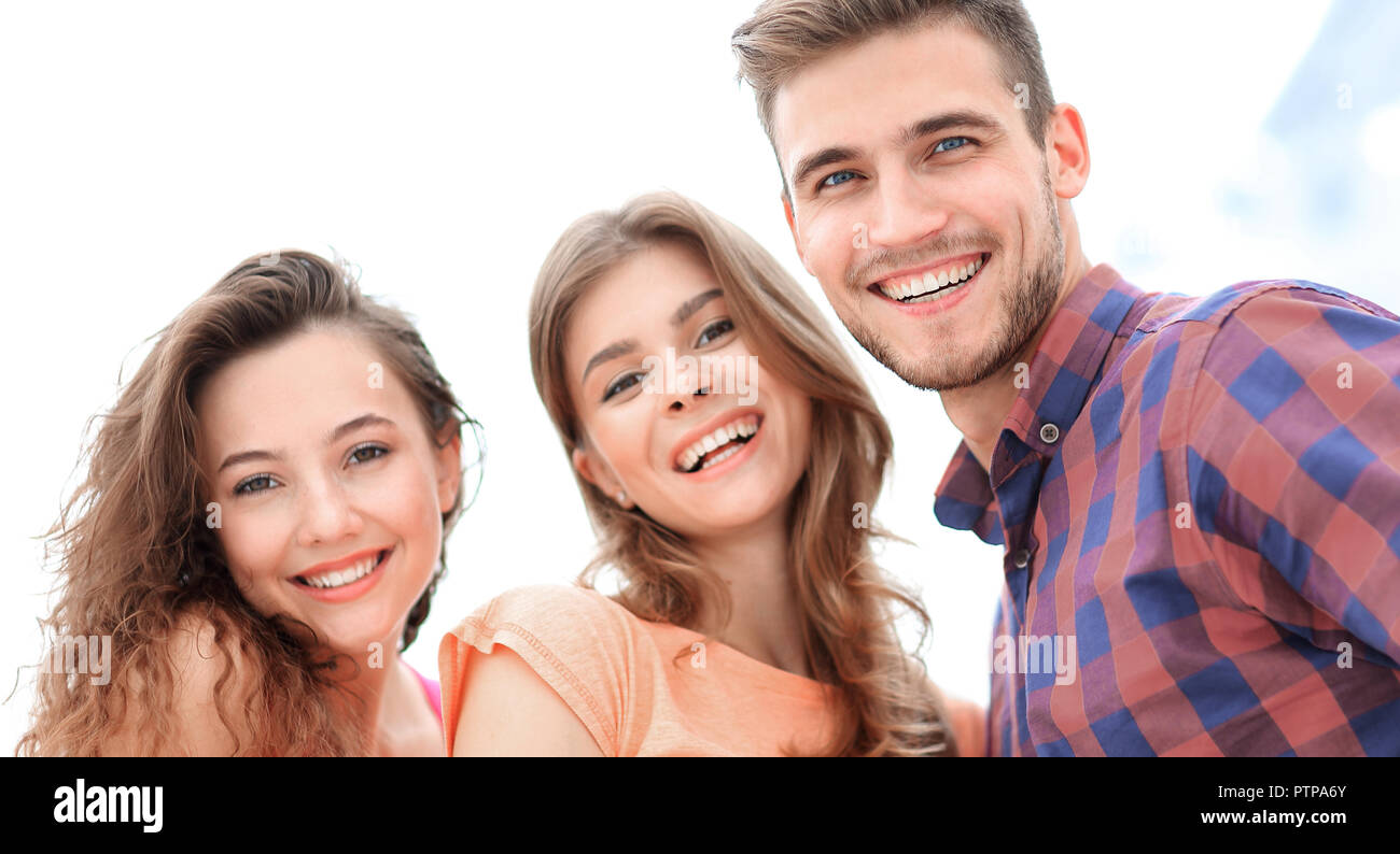 closeup of three young people smiling on white background Stock Photo ...