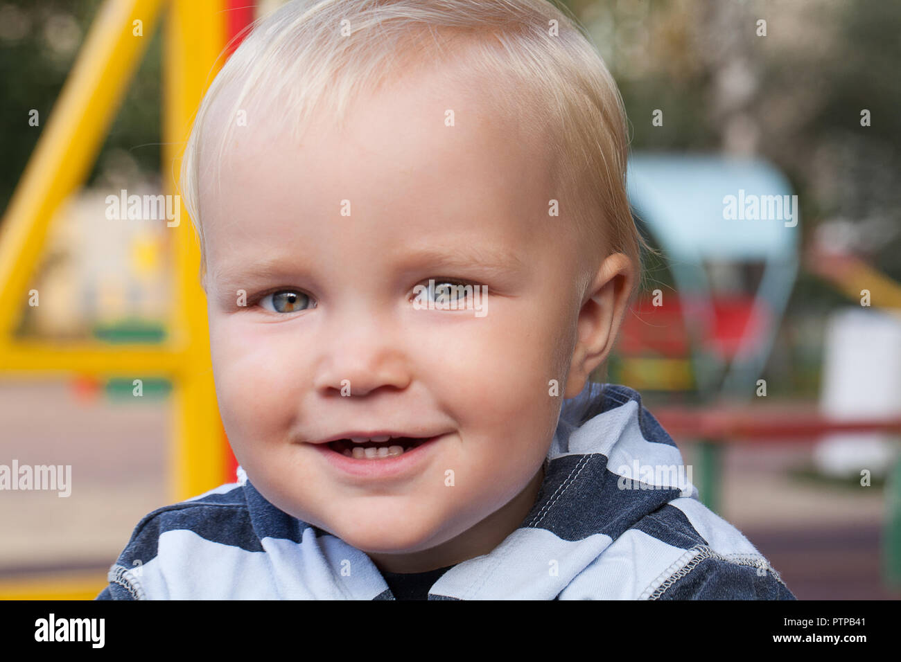 Smiling child outdoors in playground, portrait Stock Photo - Alamy