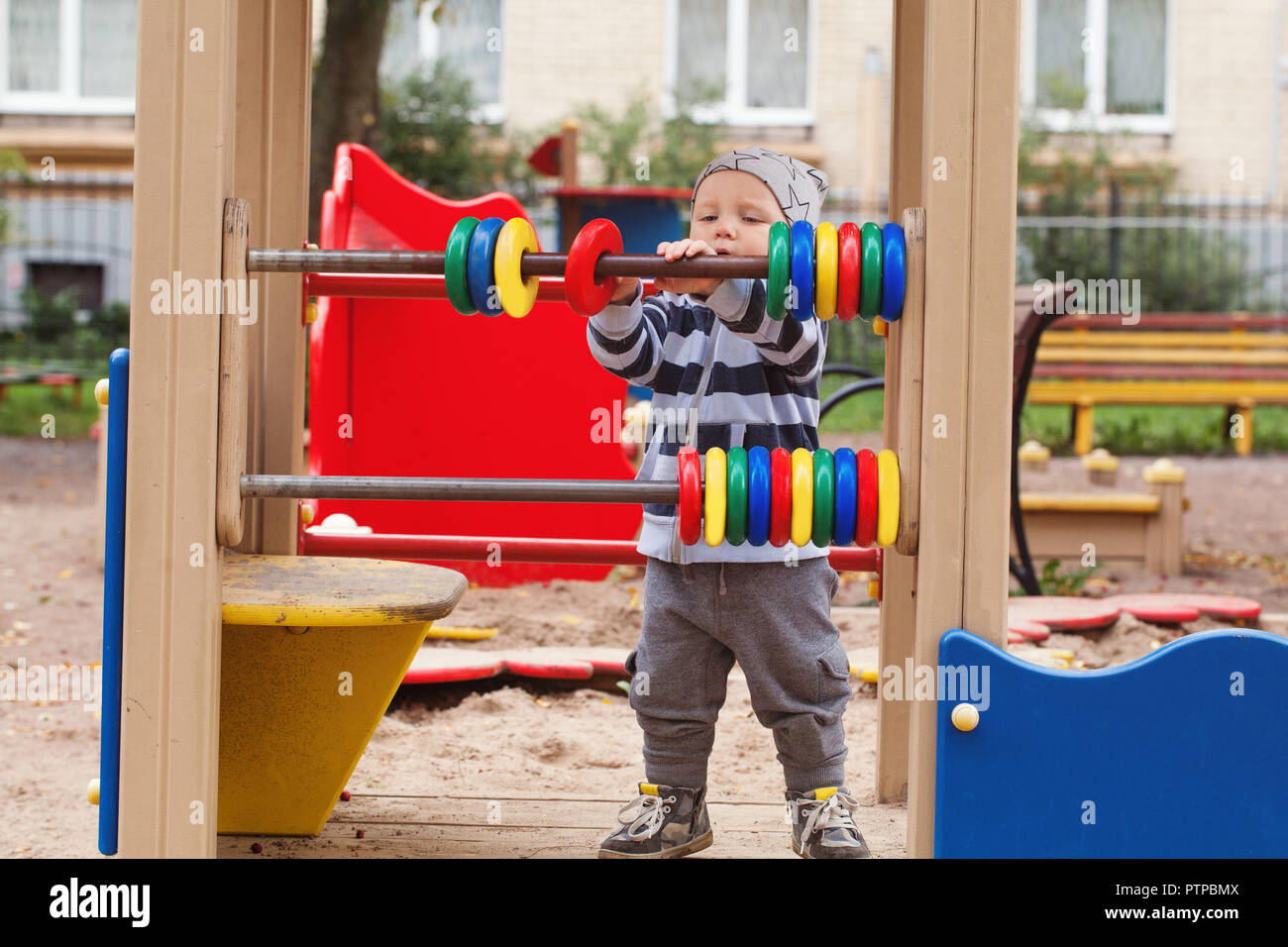 Child playing on playground. Kid in playground outdoors Stock Photo - Alamy