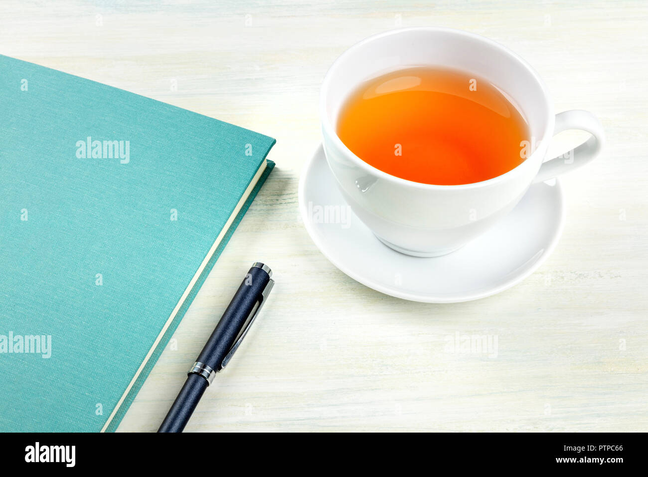 A photo of a journal with a pen and a cup of tea, with copy space Stock ...
