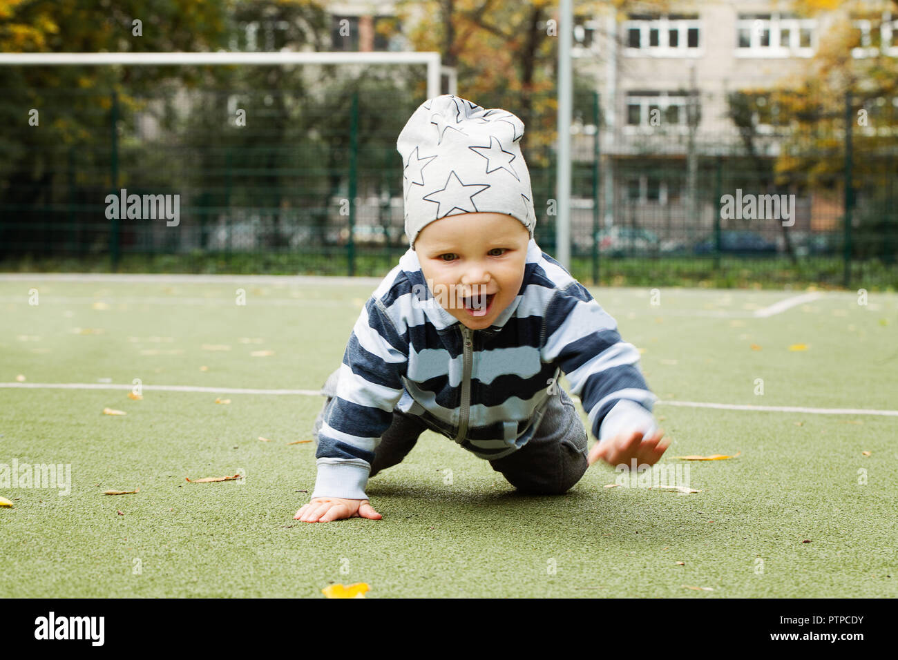 Cute child boy playing outdoors Stock Photo - Alamy