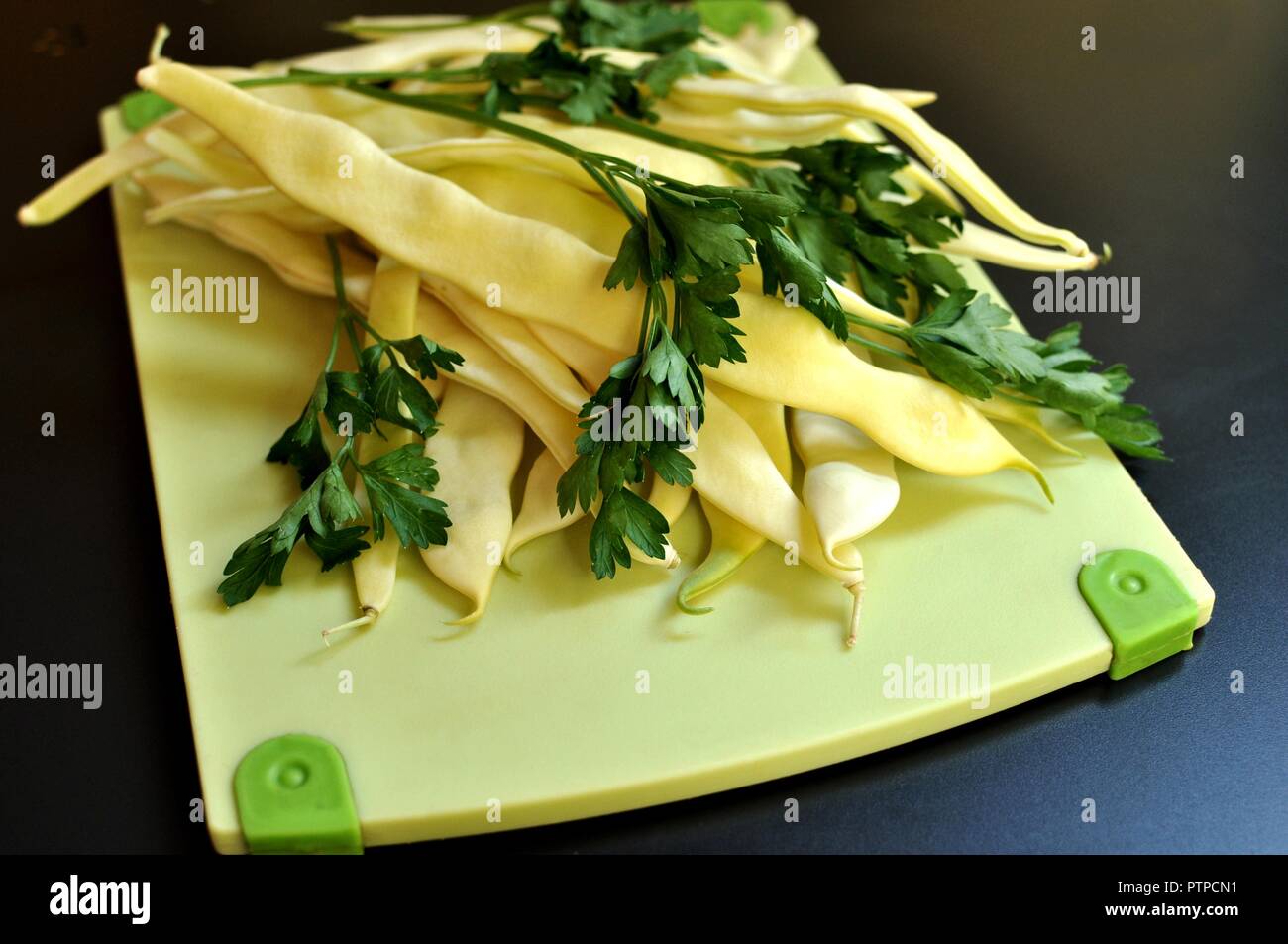 String green fresh beans seasoned with parsley on white background ...
