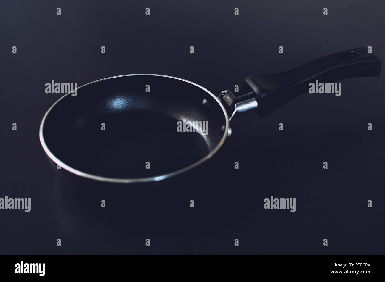 Little pan on black background Stock Photo - Alamy