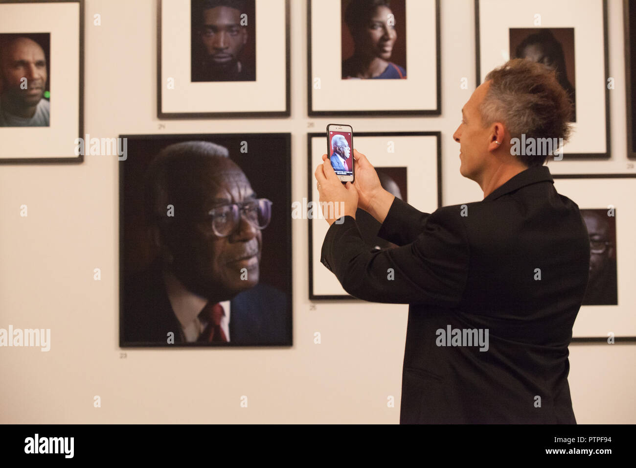 Visitors to the 'Black is the New Black' exhibition of portraits by ...