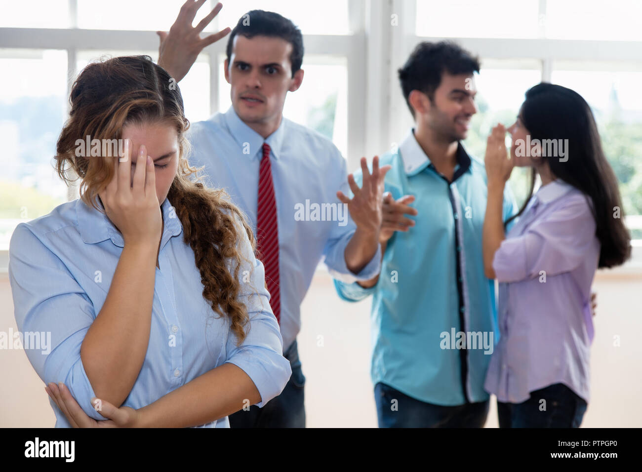 Businessman and colleagues bullying employee at office of company Stock ...