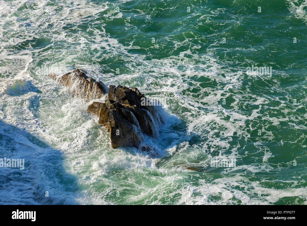 Foamy waves washing over rocky hi-res stock photography and images - Alamy