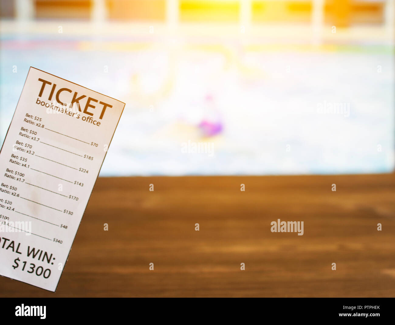 Bookmaker ticket on the background of the TV on which show water polo ...