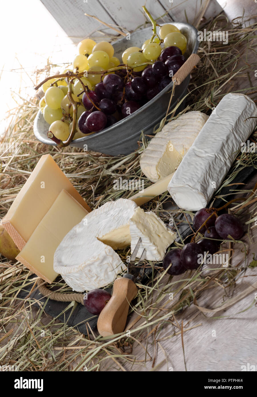 the french cheeses with bunches of red and white grapes Stock Photo - Alamy