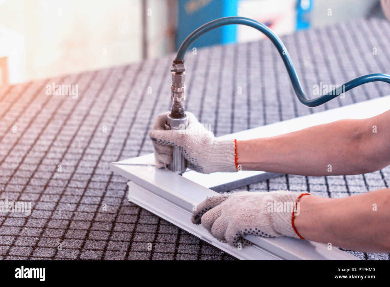 Production of pvc windows, stripping corners in a pvc frame, close-up ...