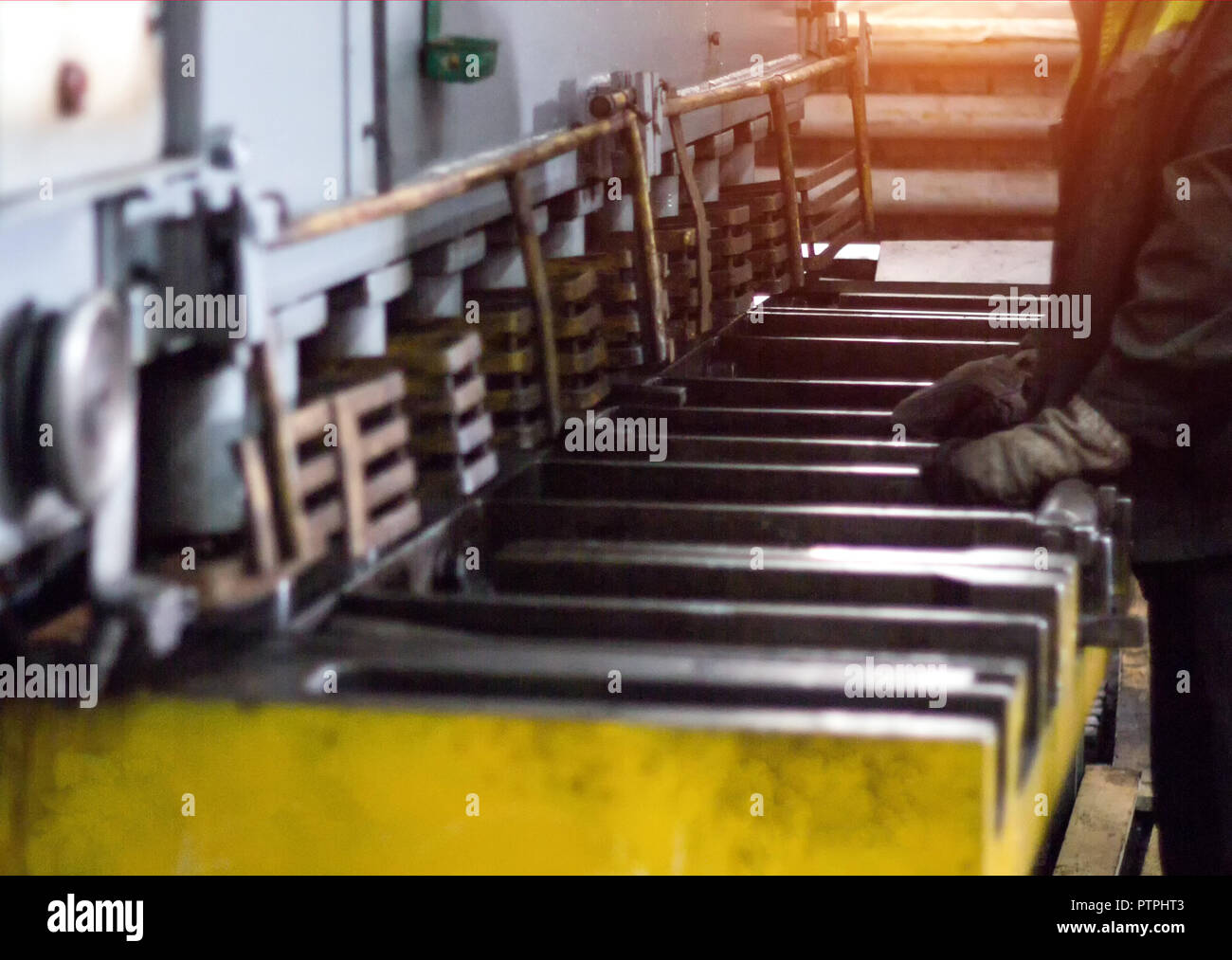 the worker is engaged in cutting of metal on the production automatic ...