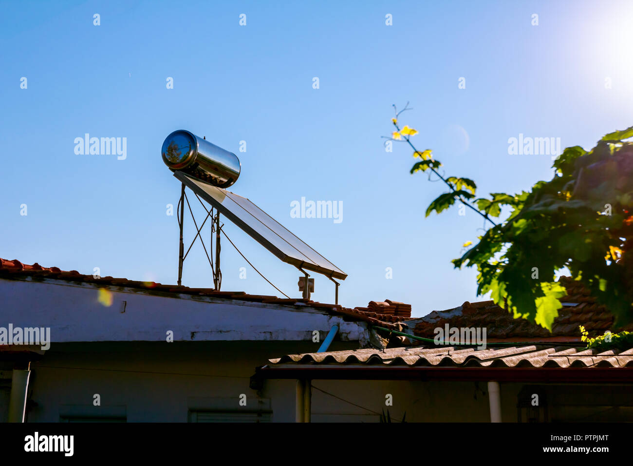 Water panels for using renewable sun energy are placed on house roof ...