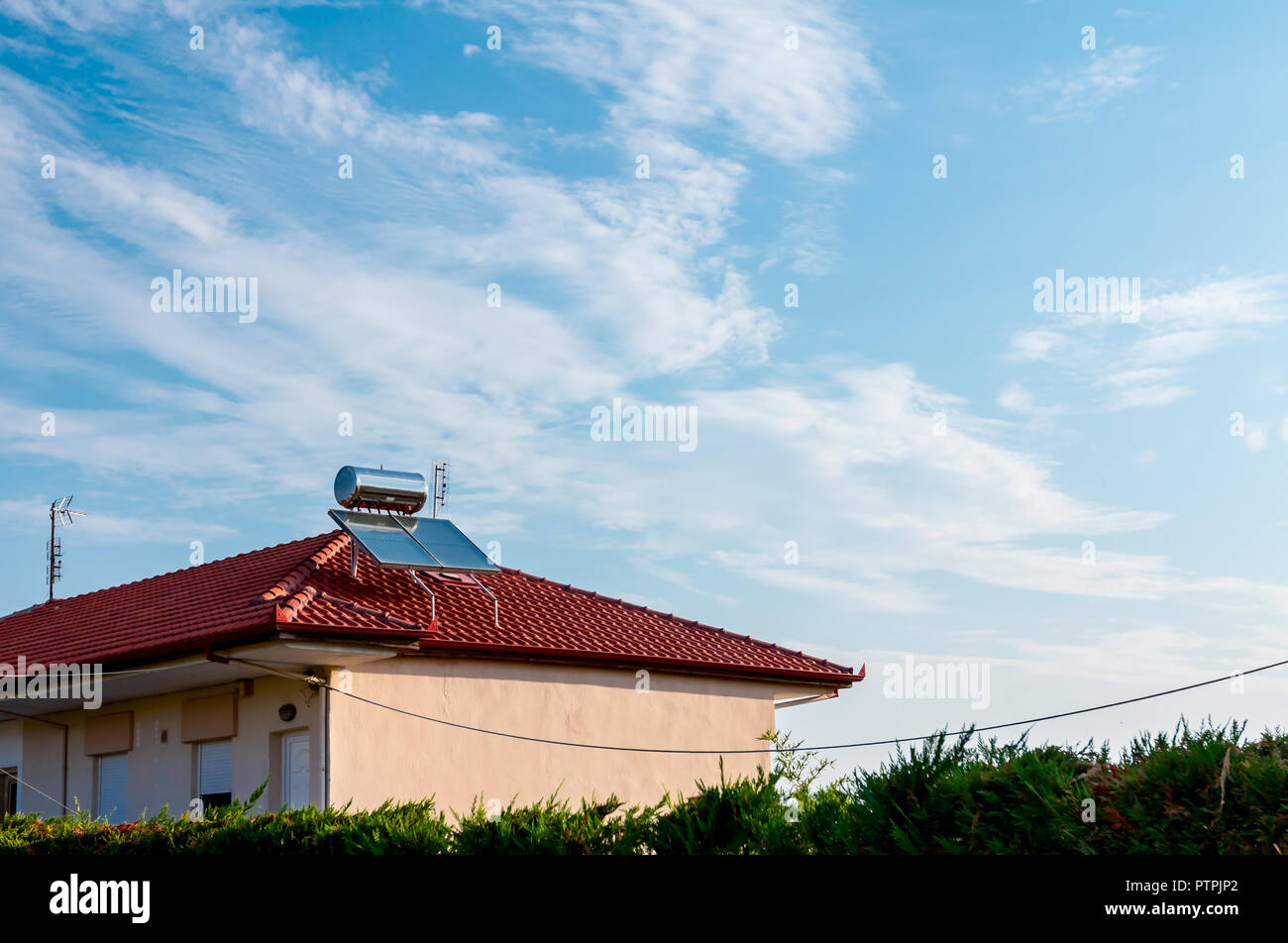 Water panels for using renewable sun energy are placed on house roof ...