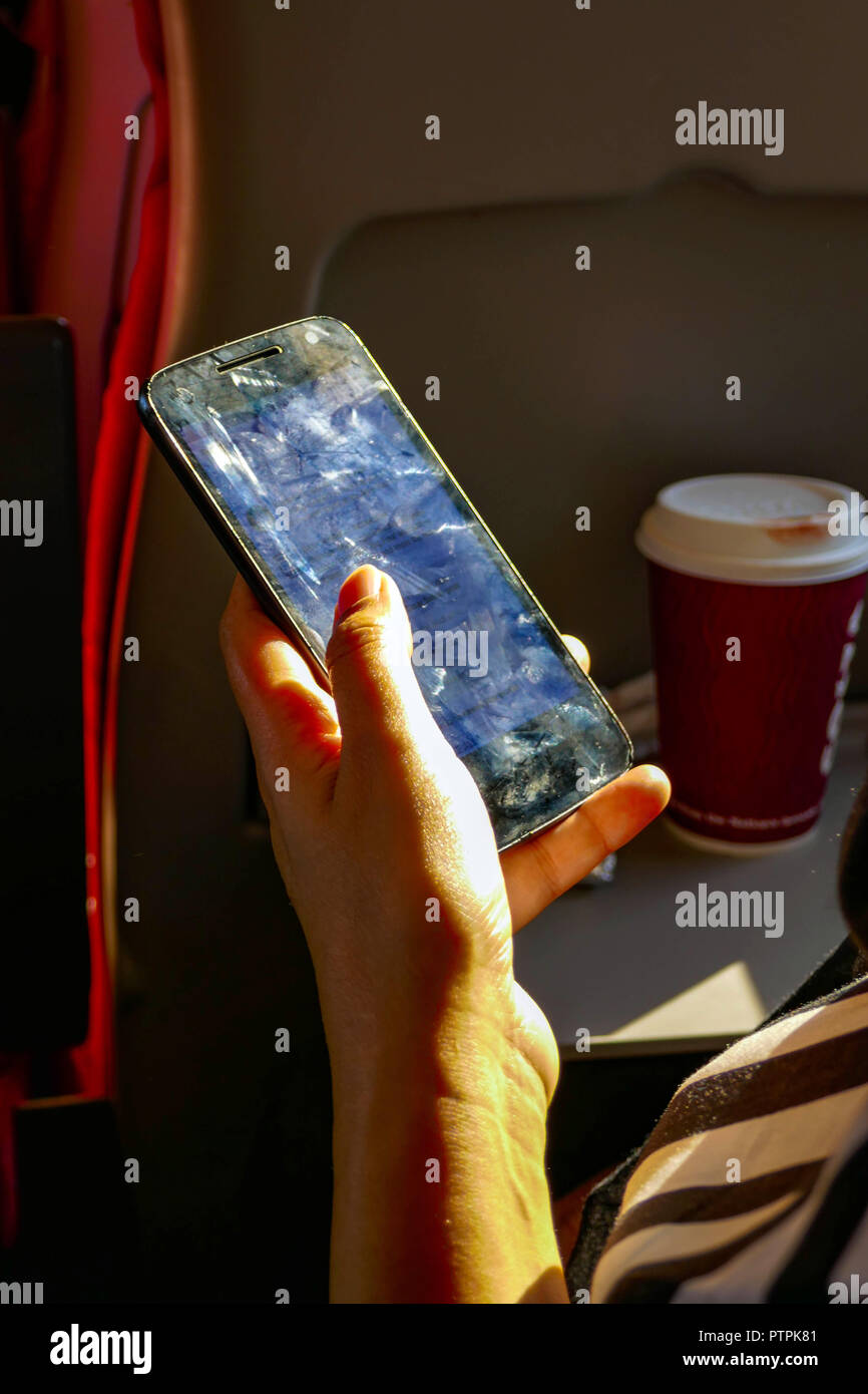 Female hand holding dirty Samsung smart phone, smart-phone in sunlight ...