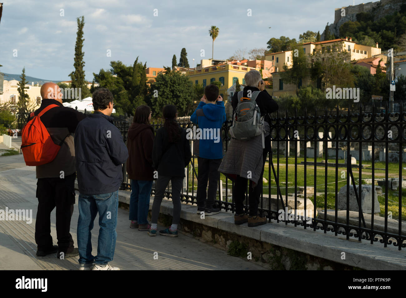 People standing at the Athens roman forum, are taking pictures of the ...