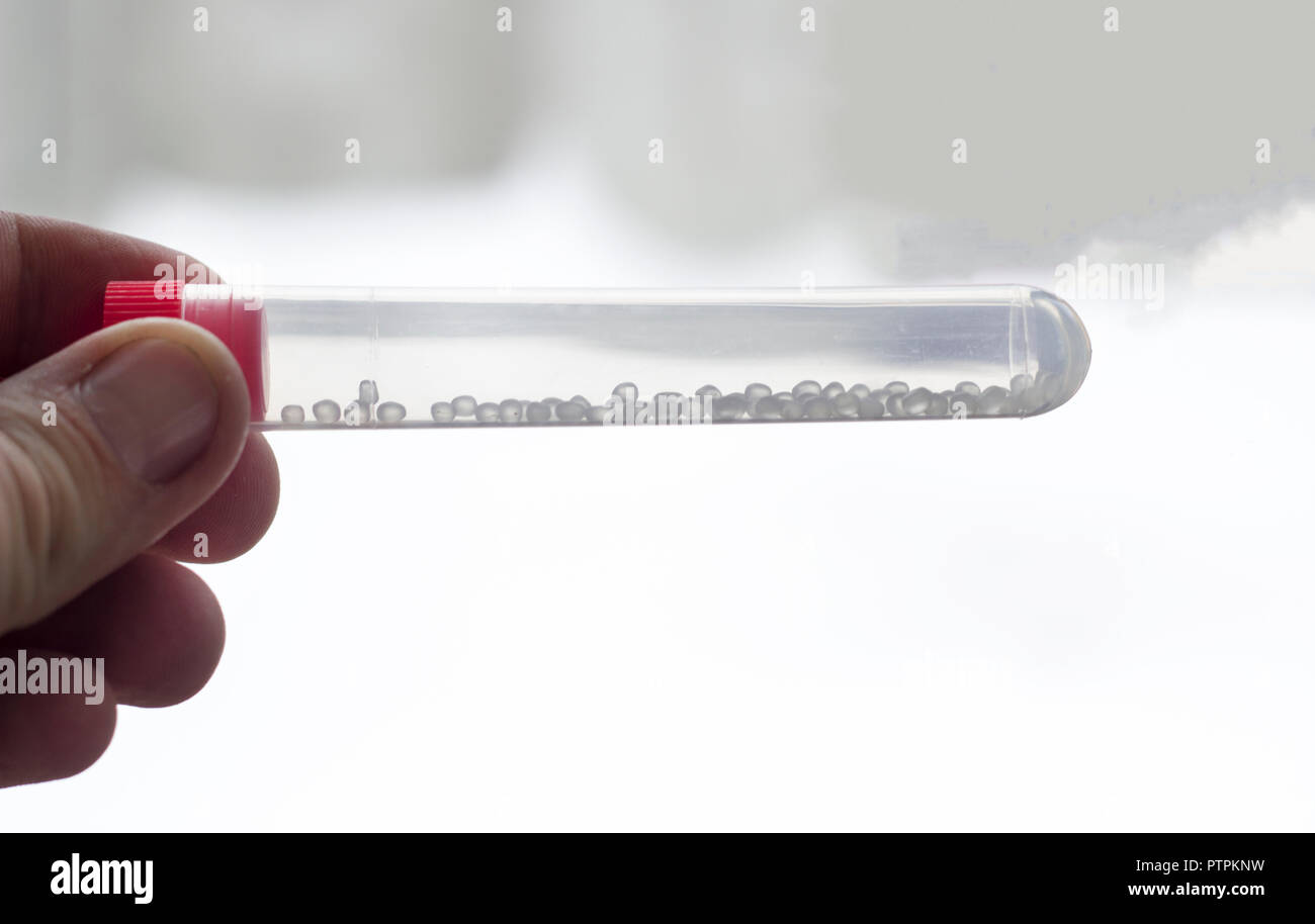 Medical tube with granules on a white background Stock Photo - Alamy
