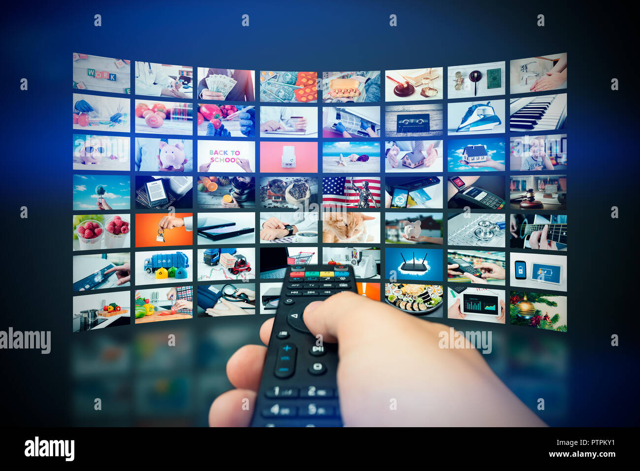 Multimedia video wall television broadcast. Hand holding remote control ...