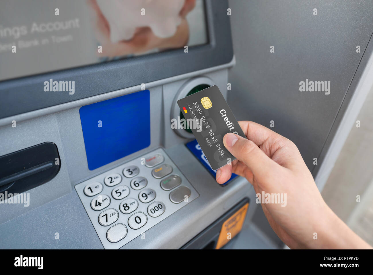 Man hand puts credit card into ATM. Money is withdrawn from an ATM ...