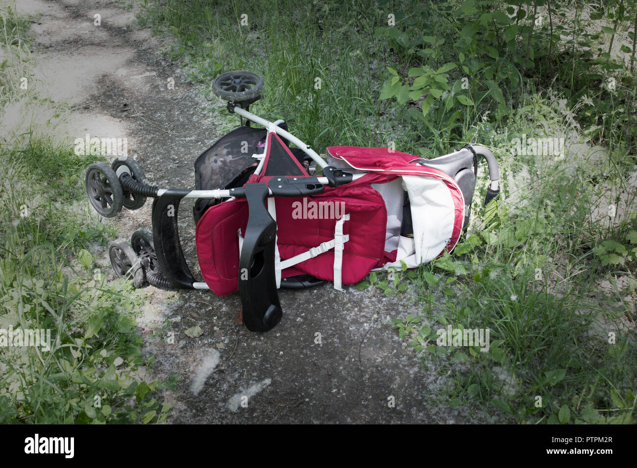 Inverted baby carriage rests on a forest road, kidnapping a child ...