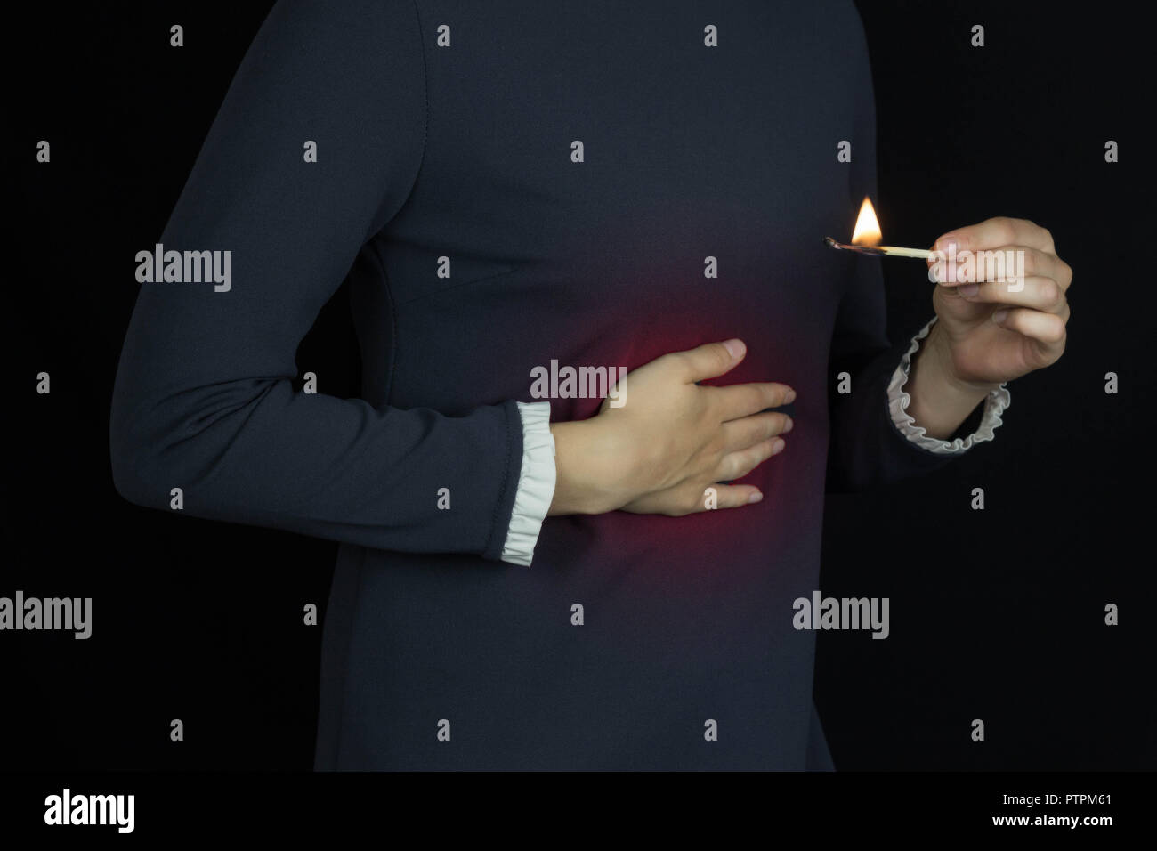 The girl holds on to the stomach, heartburn in her stomach, fire and ...