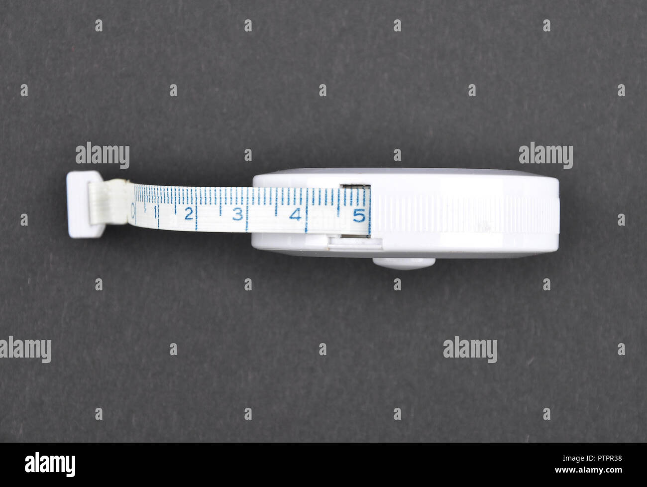 Measuring tape on black background Stock Photo - Alamy