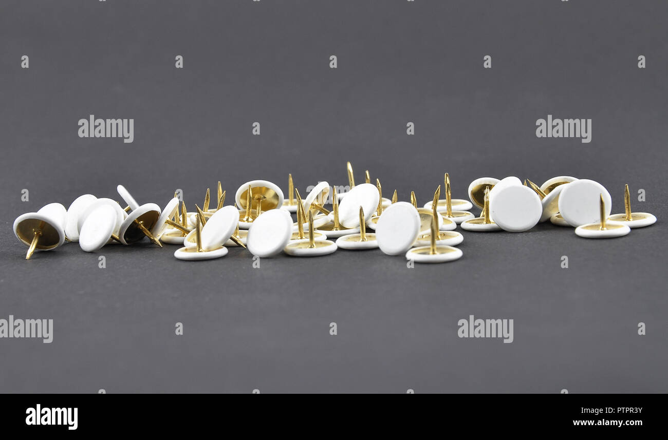 Drawing pins on black Stock Photo - Alamy
