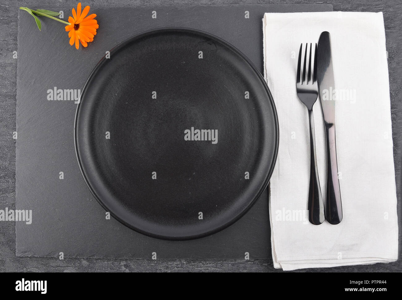 Common marigold and table setting on slate Stock Photo - Alamy