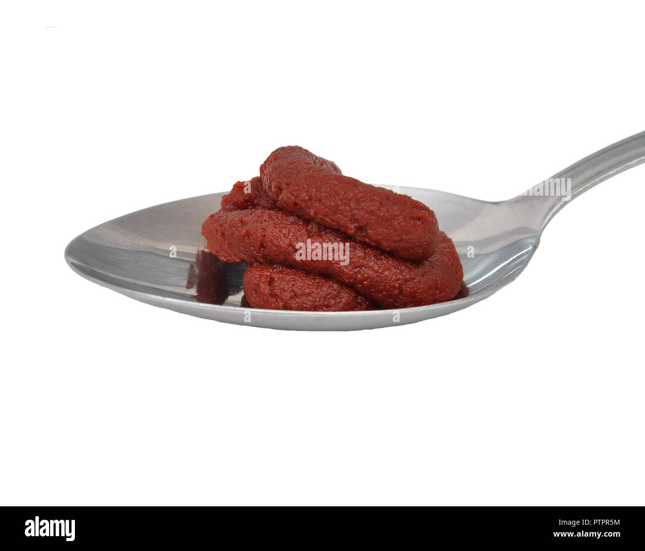 Tomato puree on spoon and white Stock Photo - Alamy