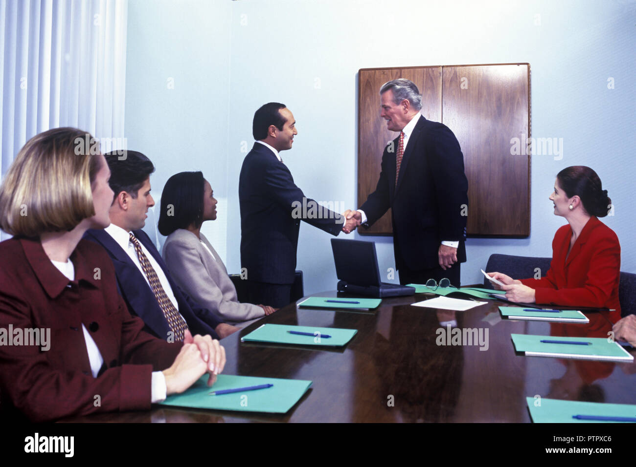 1995 HISTORICAL MULTI ETHNIC OFFICE WORKERS IN LARGE GROUP BOARDROOM ...