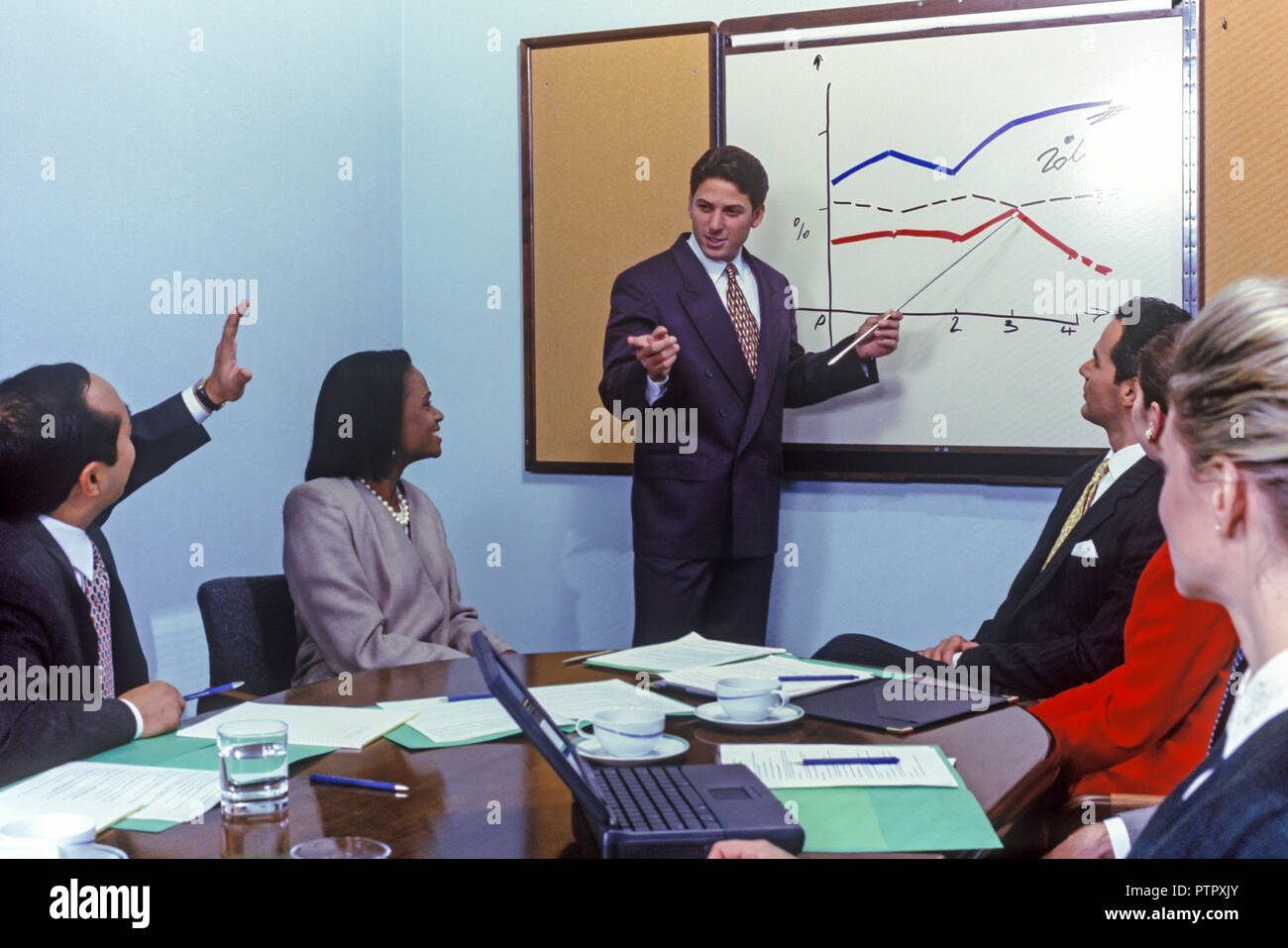 1995 HISTORICAL MULTI ETHNIC OFFICE WORKERS IN LARGE GROUP BOARDROOM ...
