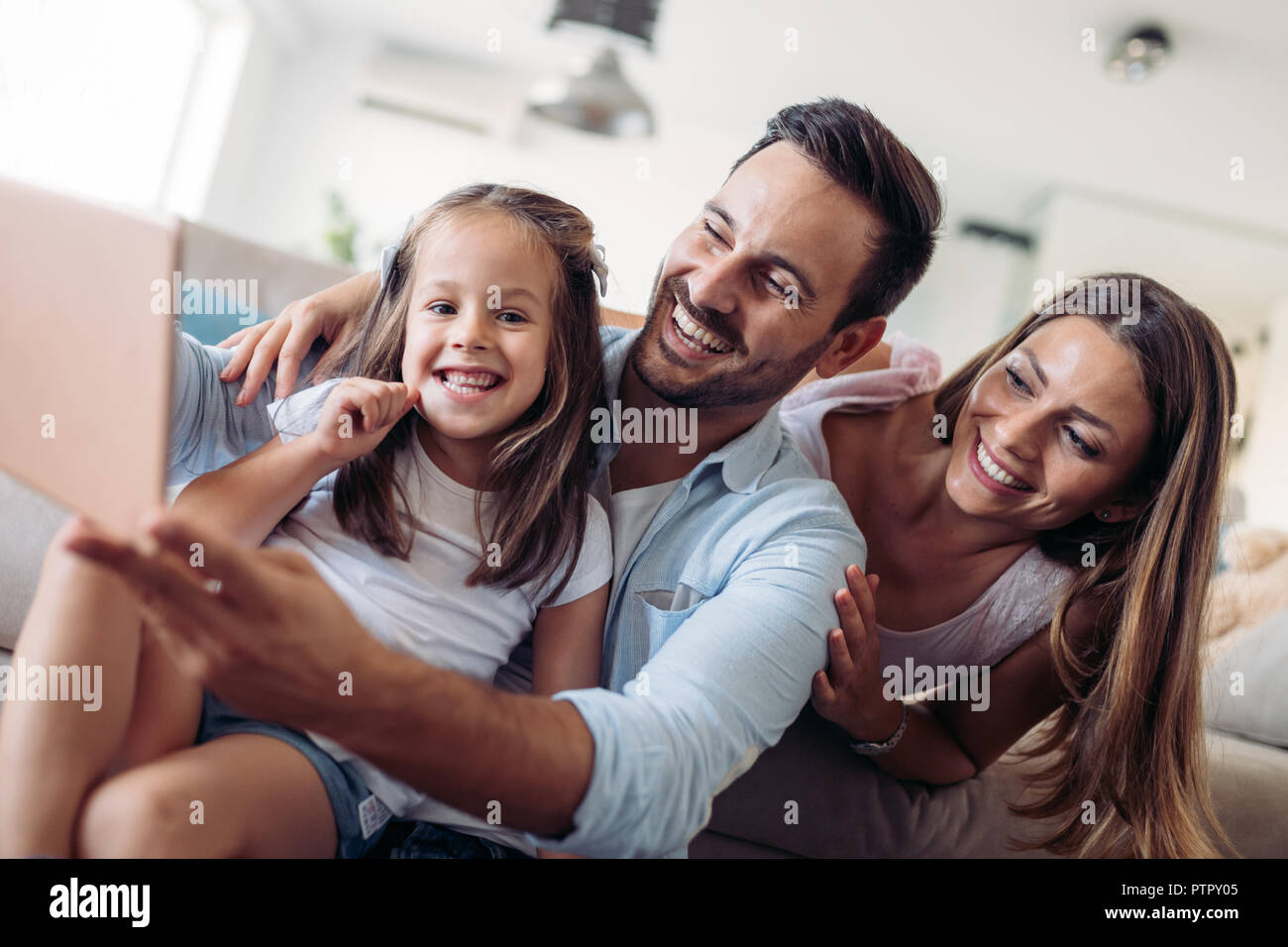 Happy family having fun time at home Stock Photo - Alamy