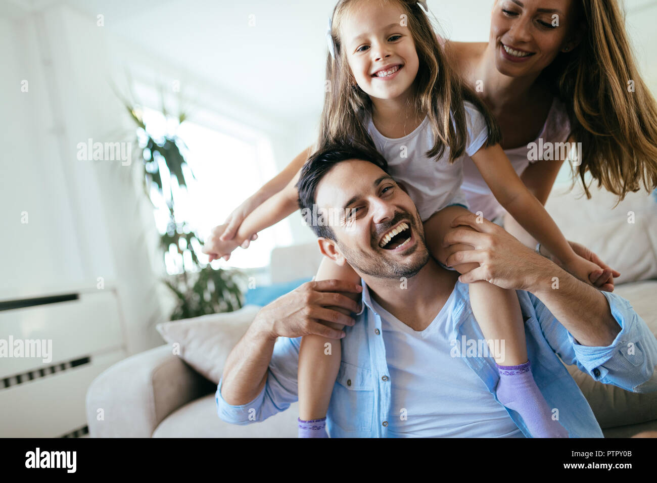 Happy family having fun time at home Stock Photo - Alamy