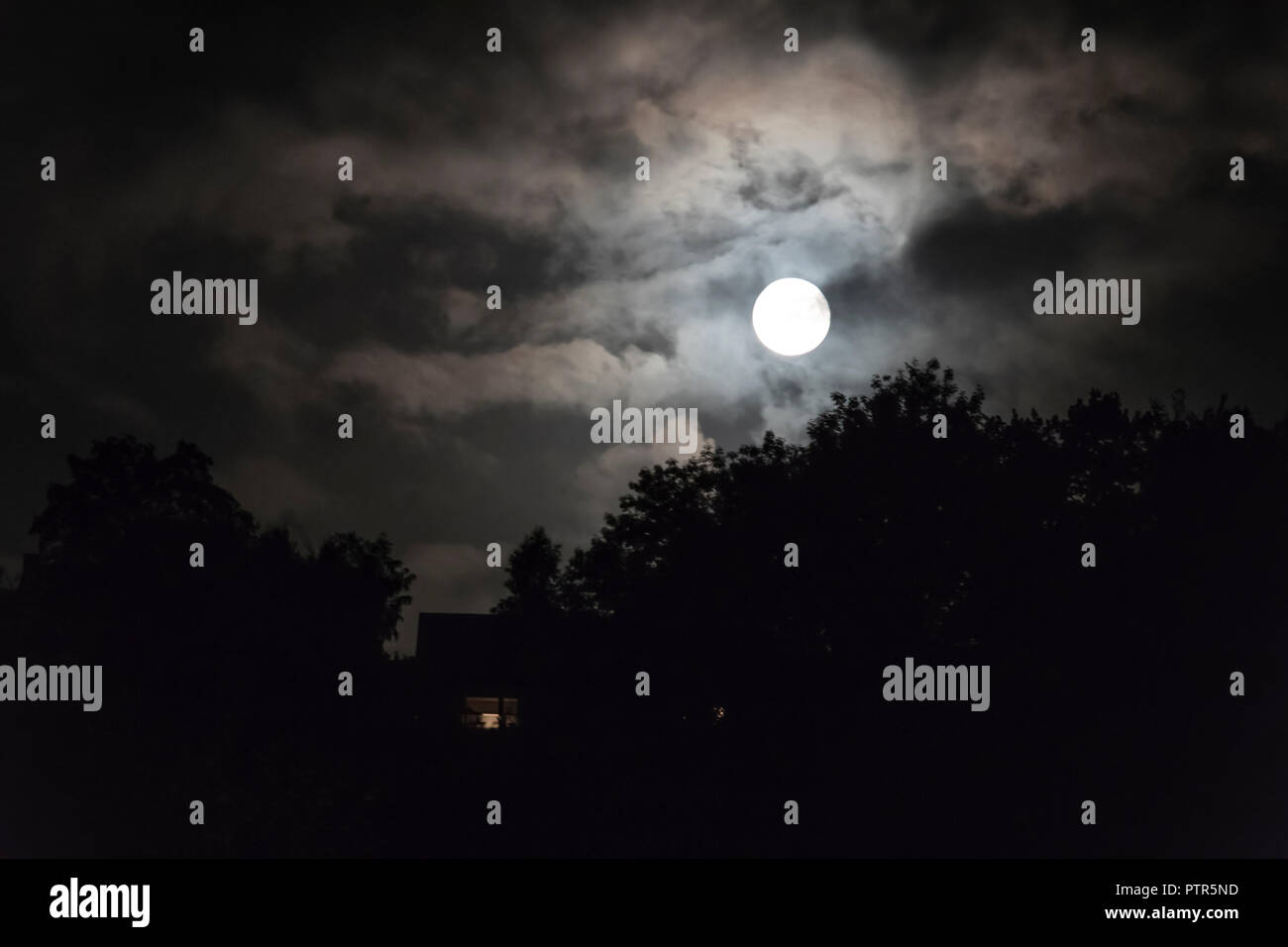 A full moon captured in the morning Stock Photo - Alamy