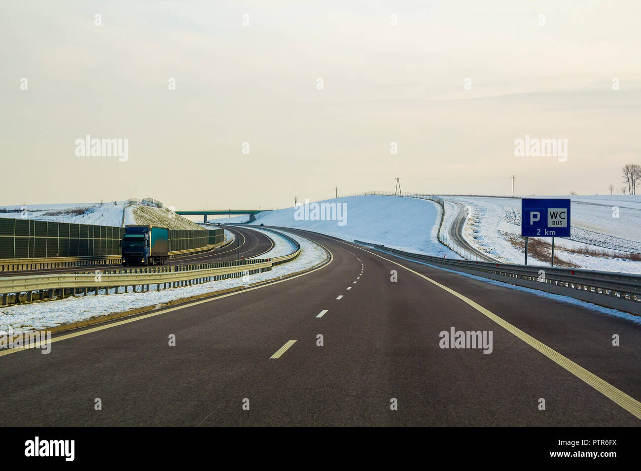 Modern wide smooth empty asphalt highway stretching to horizon under ...