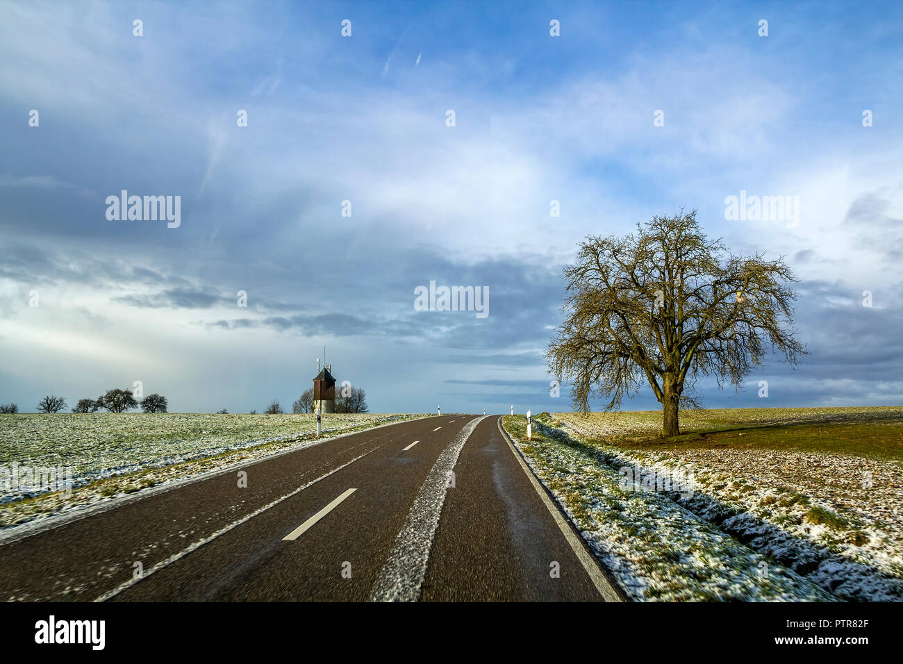 Empty black asphalt road between green fields Stock Photo - Alamy