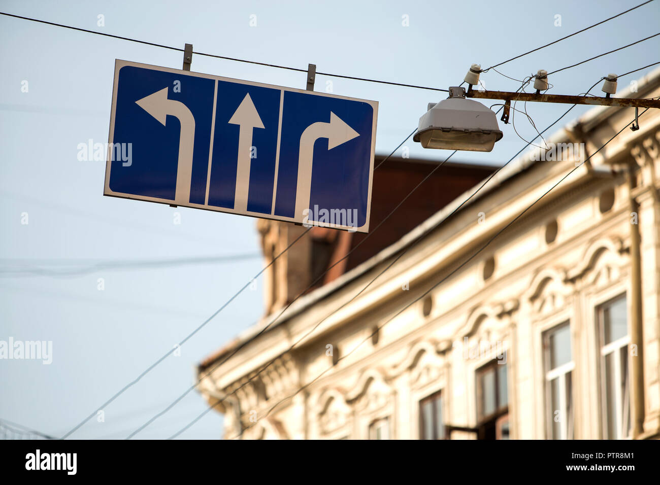 Close-up of road sign attached to trolley line near the lamp high over ...