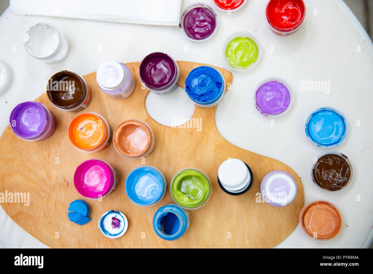 Palette with open jars of paints and of the artist on the white Stock ...