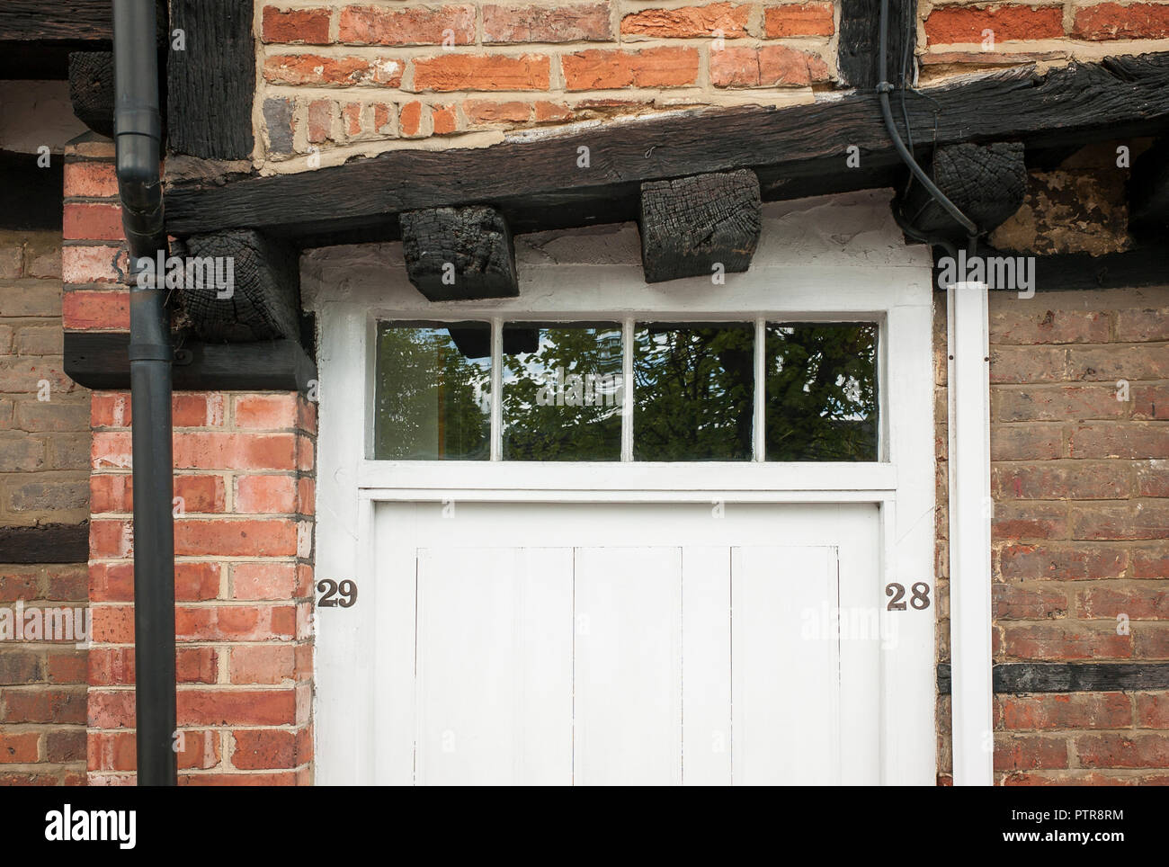 Contrasting architectural styles reflected in an old timber framed ...