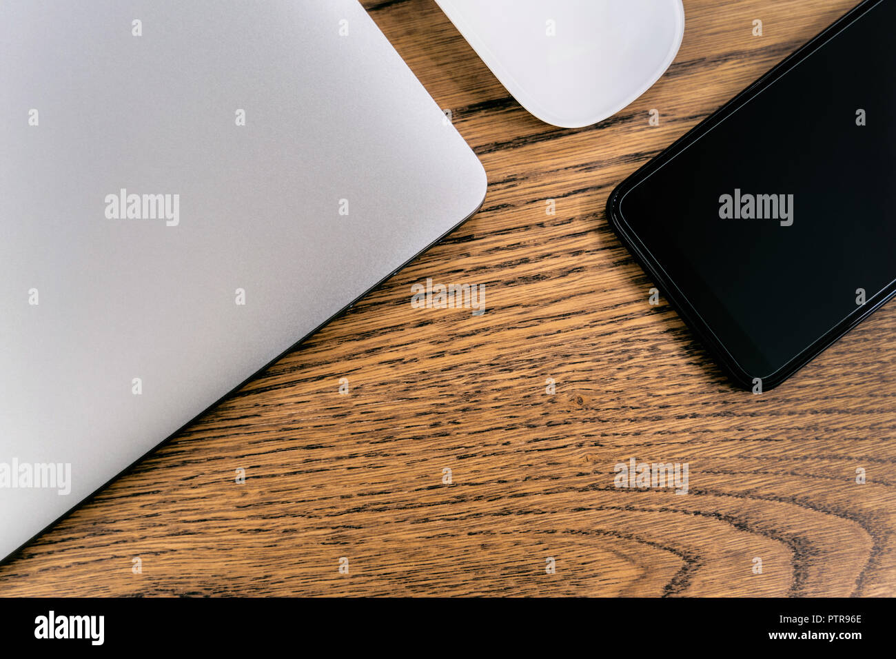 Laptop computer and smartphone, mouse on table. Office concept Stock ...