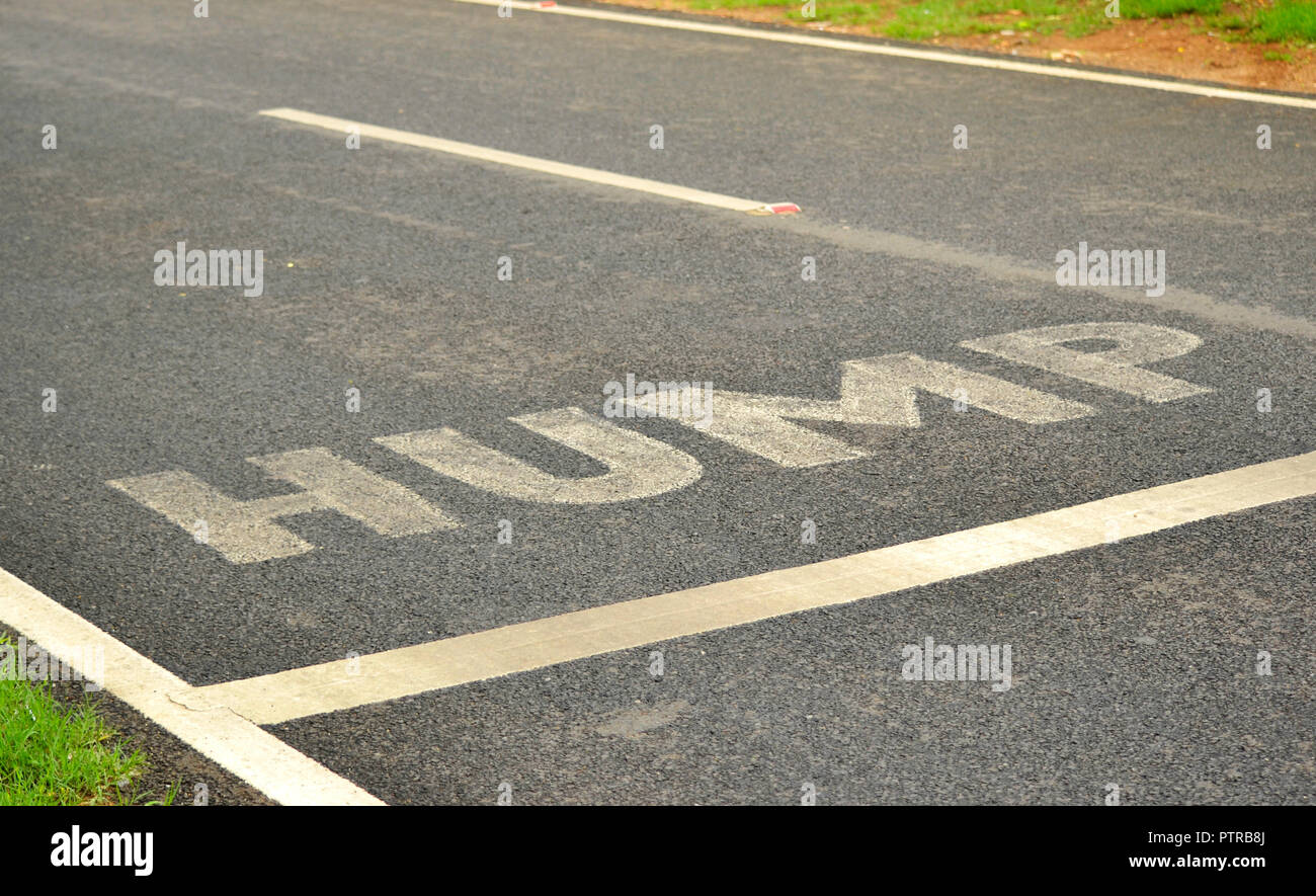 Hump Warning Sign Written On Road Stock Photo - Alamy