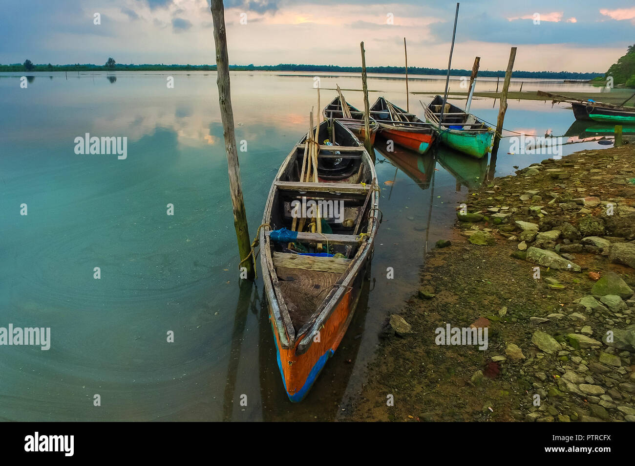 Sunset Over River With Fishing Boats Stock Photo - Alamy