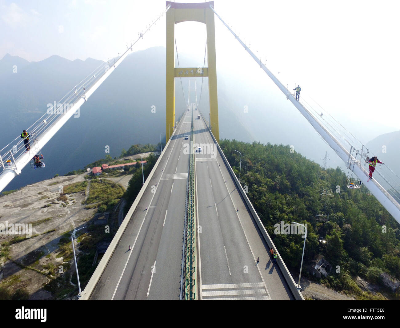 Enshi. 10th Oct, 2018. Staff members carry out cleaning and maintenance ...