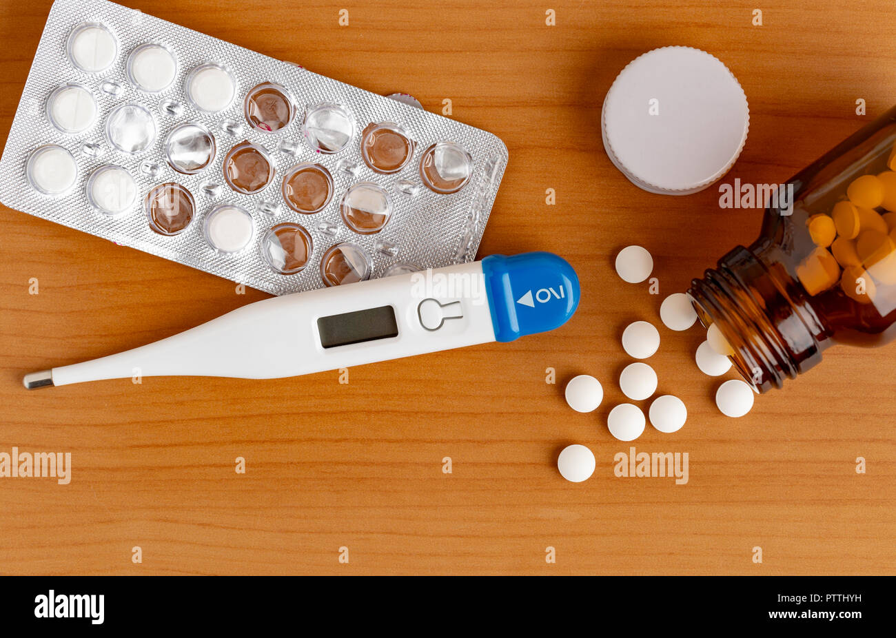 digital thermometer, empty medicine blister and bottles of pills.top ...