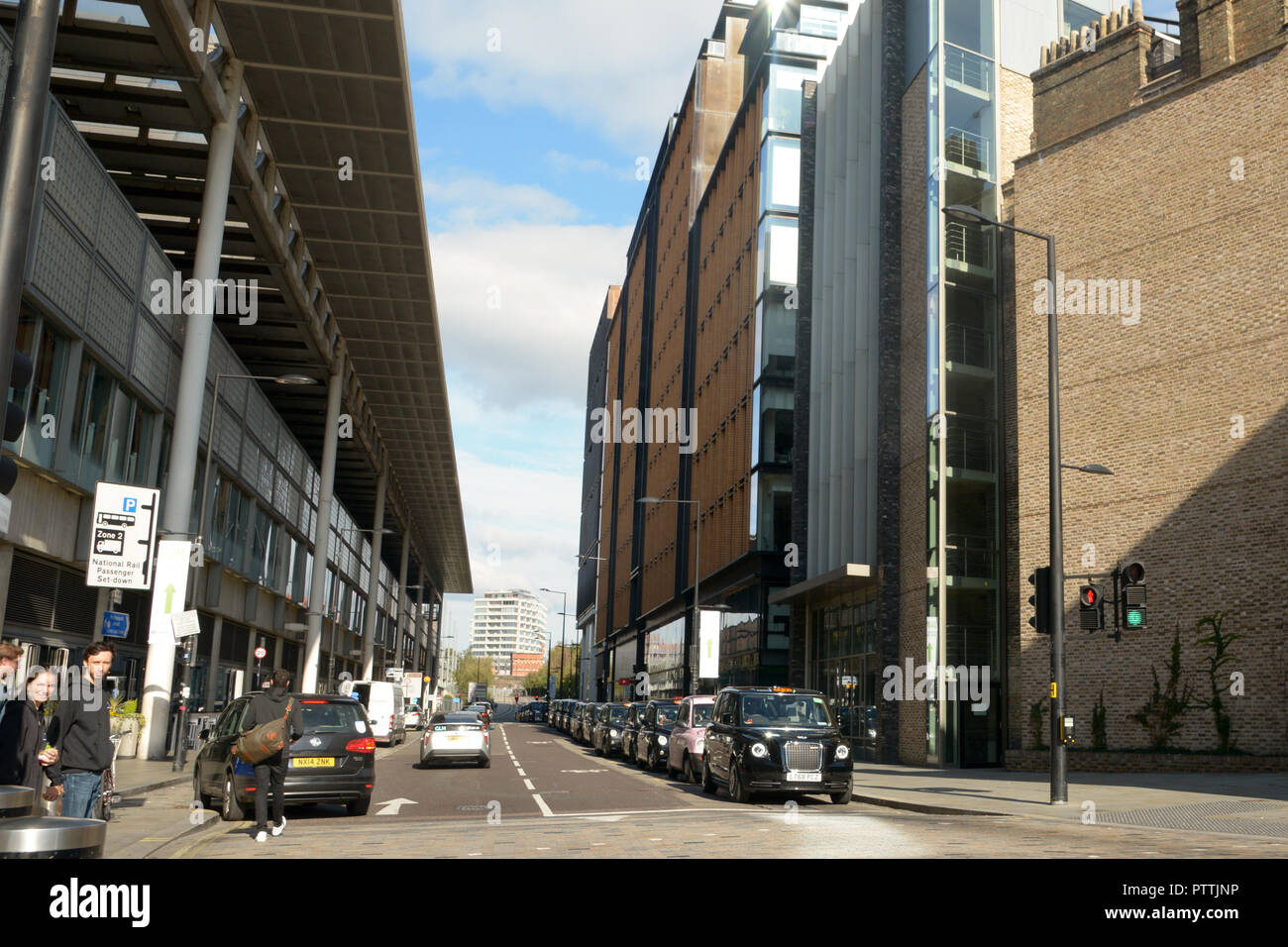 Queue of black cab London taxis on Pancras Road next to St Pancras ...